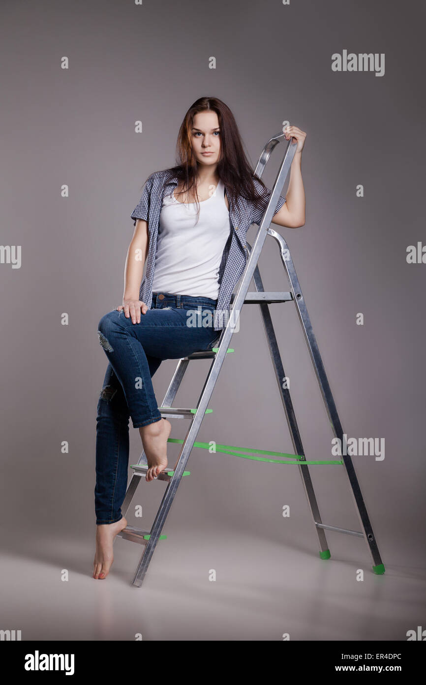 Young woman on step ladder Stock Photo - Alamy