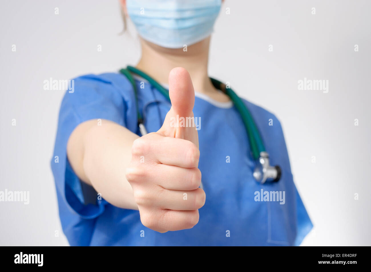 Female doctor showing thumbs up sign Stock Photo - Alamy