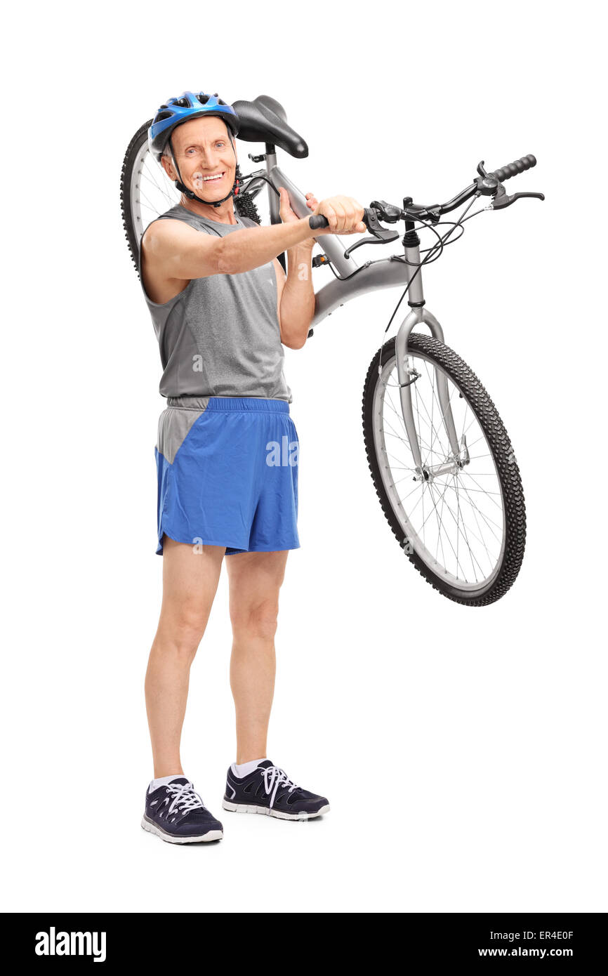 Full length portrait of an active senior biker carrying his bicycle ...