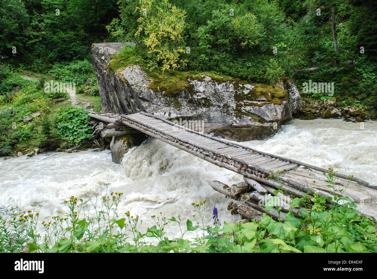 Bridge over mountain river Stock Photo - Alamy