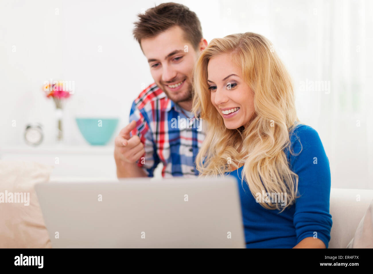 Man showing something on computer his girlfriend Stock Photo - Alamy