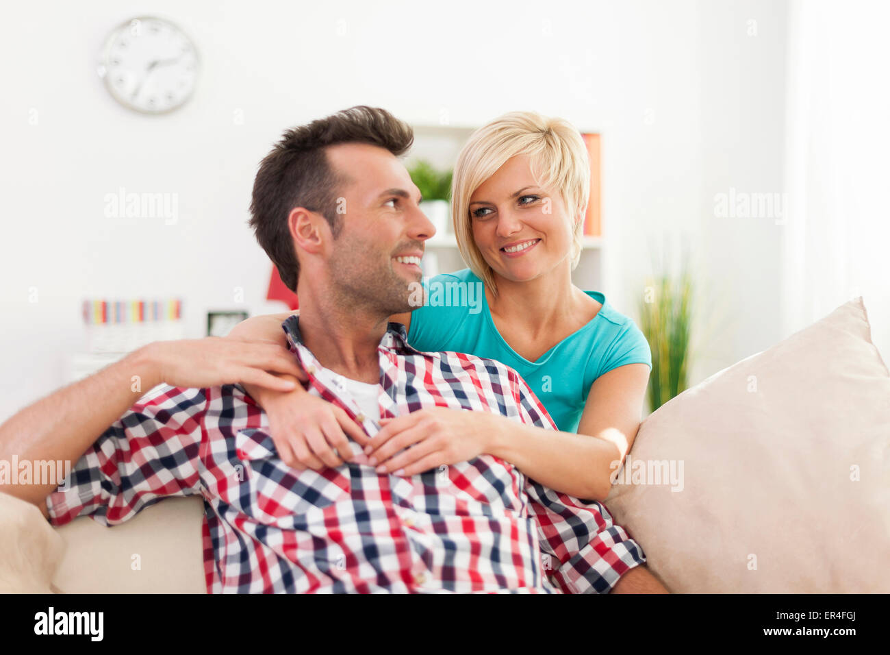 Couple flirting on sofa hi-res stock photography and images - Alamy