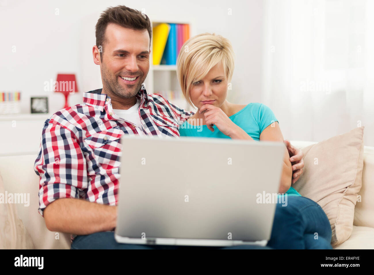 Young couple laptop joy hi-res stock photography and images - Alamy