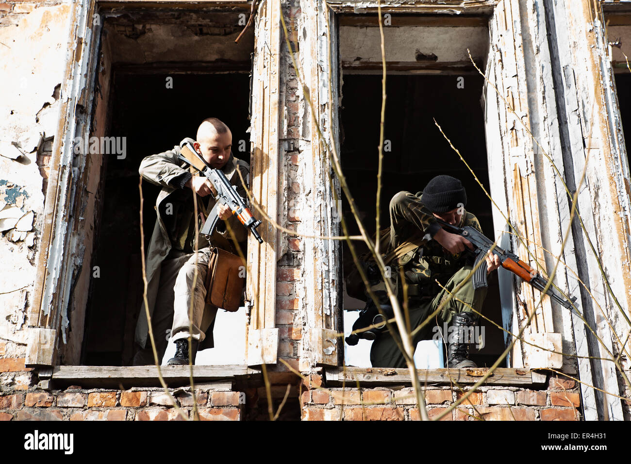 Two young males aiming with their guns Stock Photo - Alamy