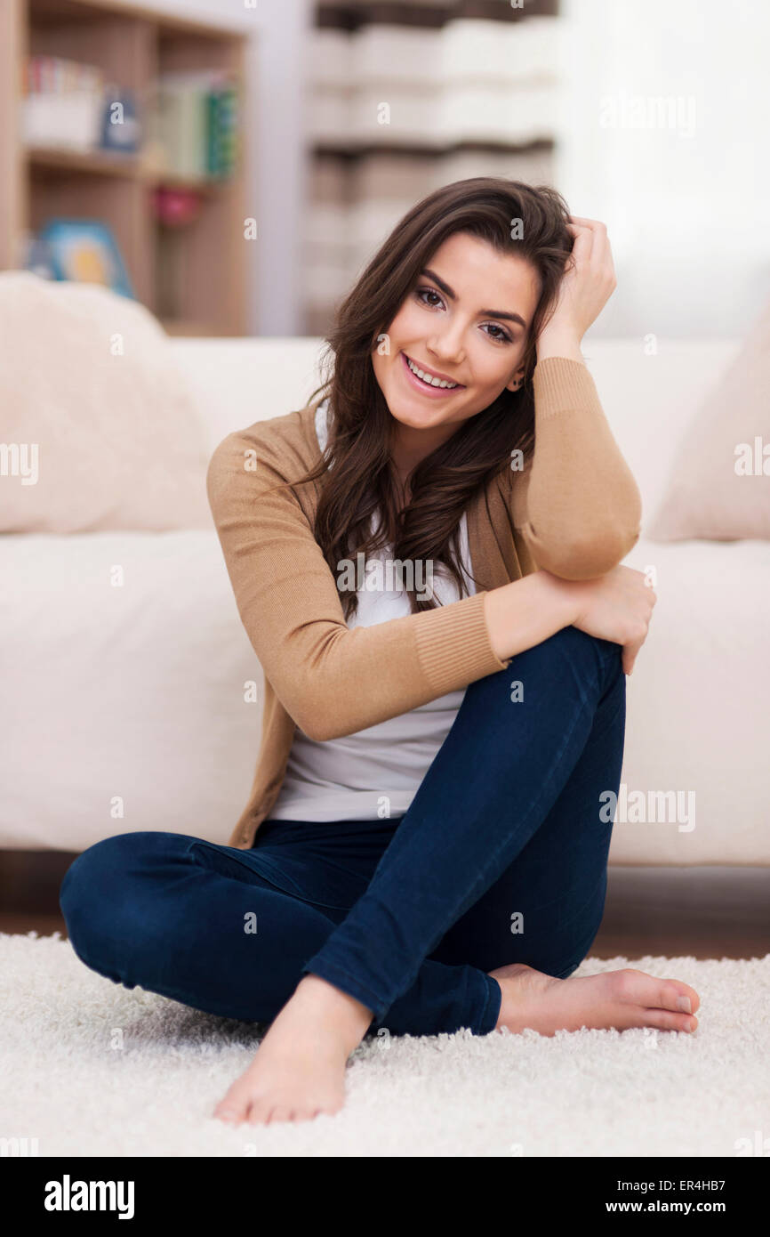 Beautiful woman relaxing in her lounge Stock Photo - Alamy