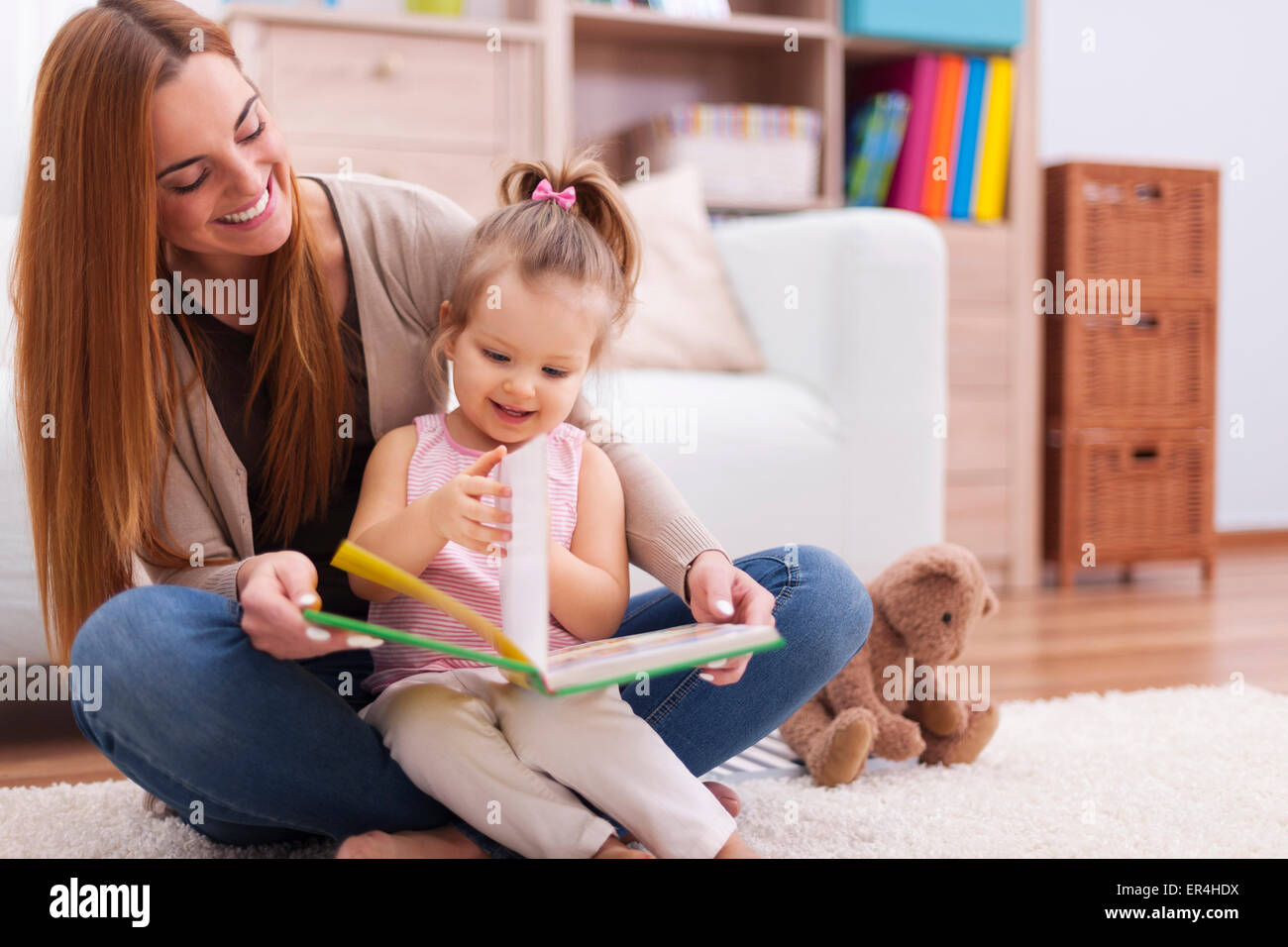 Mother and child reading book at home. Debica, Poland Stock Photo - Alamy