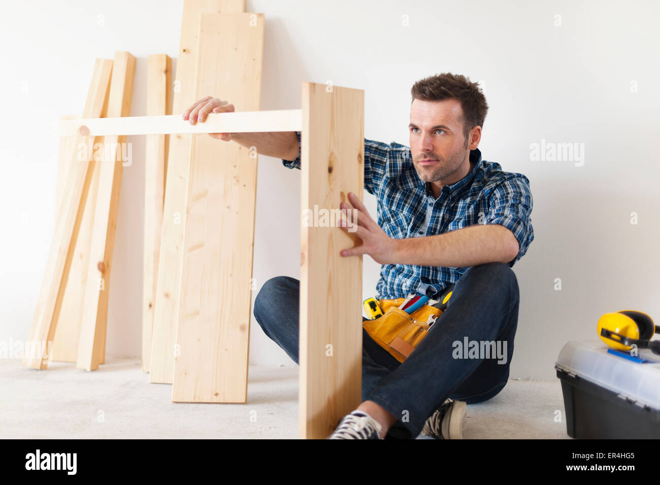 Handsome carpenter working on new furniture. Pilzno, Poland Stock Photo ...