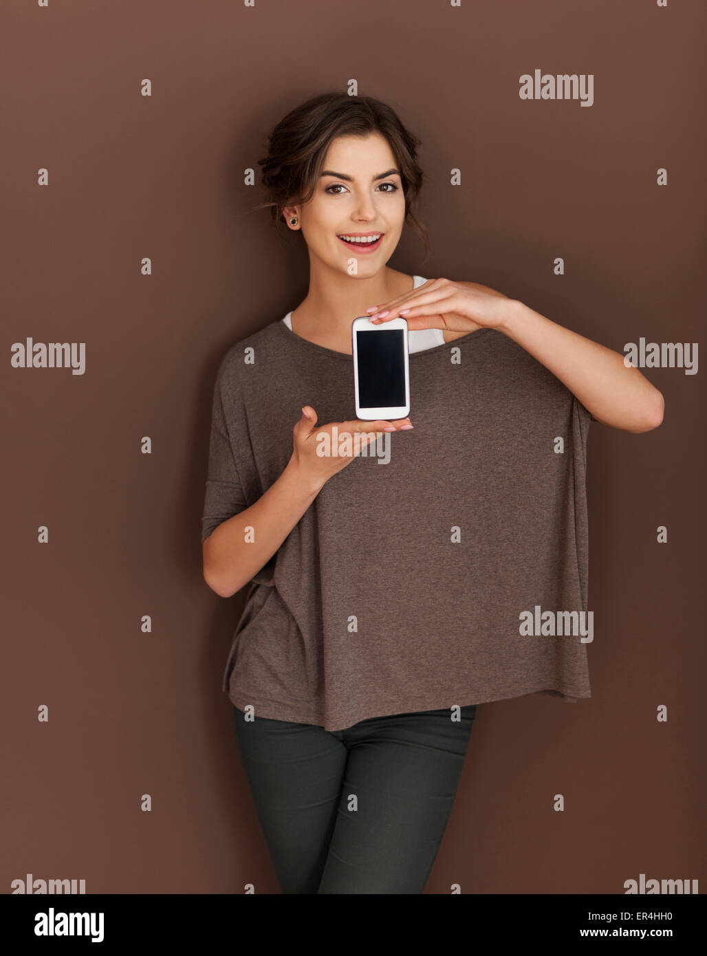 Beautiful woman posing with a smartphone Stock Photo - Alamy