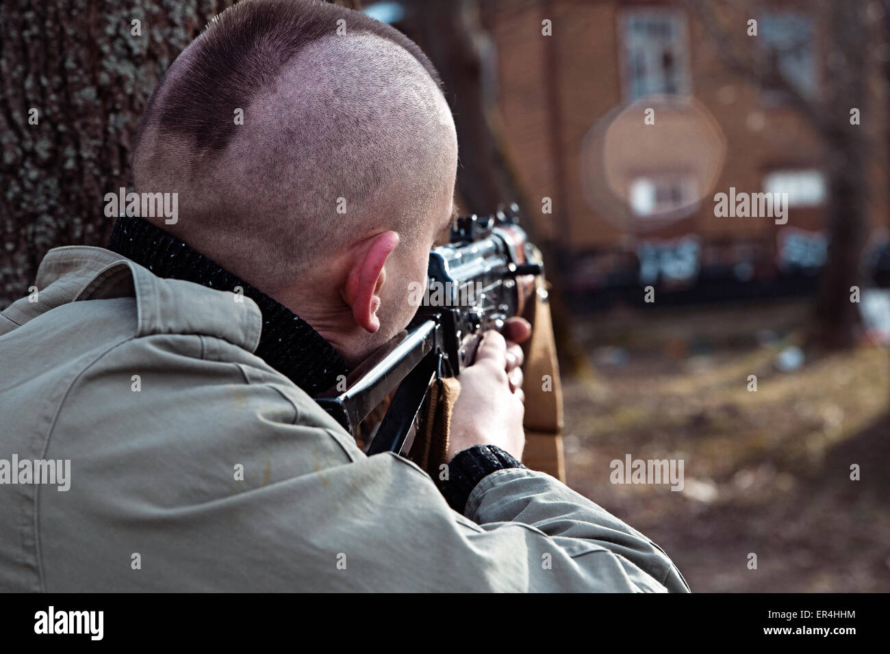 Shaved skinhead is aiming at the window Stock Photo - Alamy