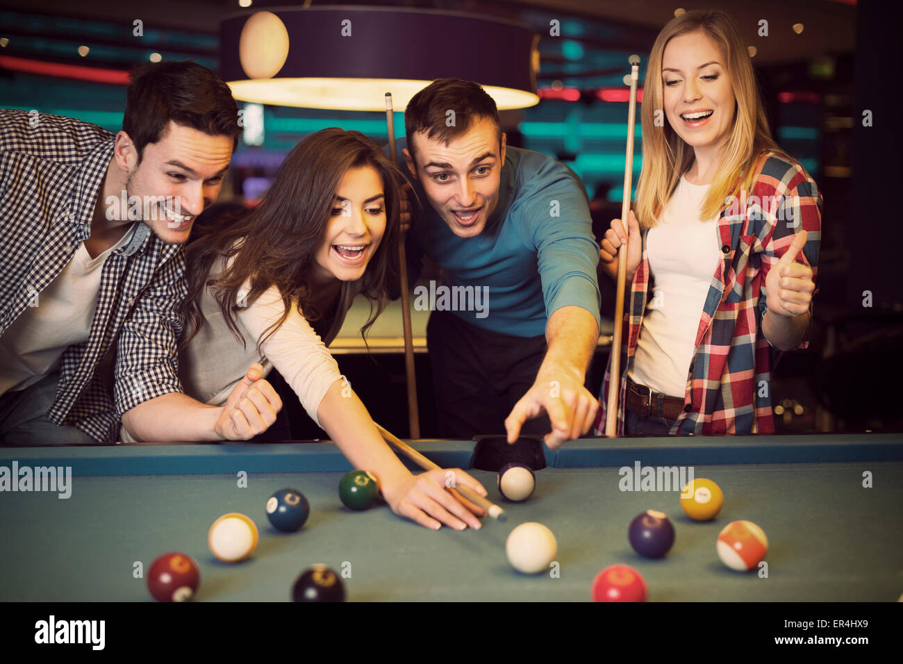 Friends playing pool at a bar Stock Photo - Alamy