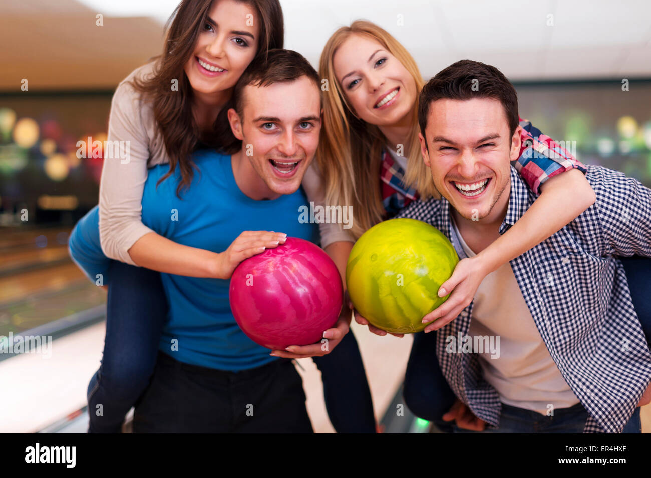 Friends bowling together Stock Photo - Alamy
