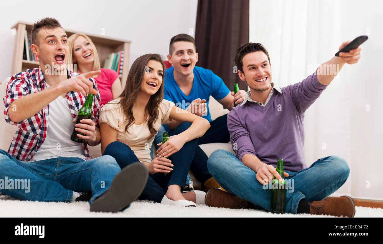 Friends watching football together Stock Photo - Alamy