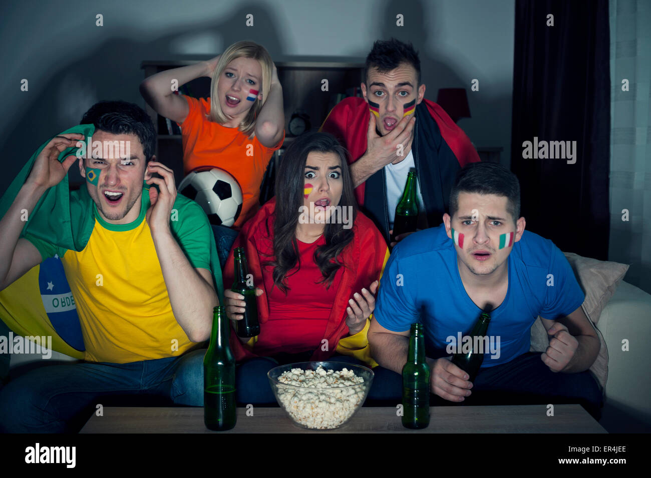 Friends watching football together Stock Photo - Alamy