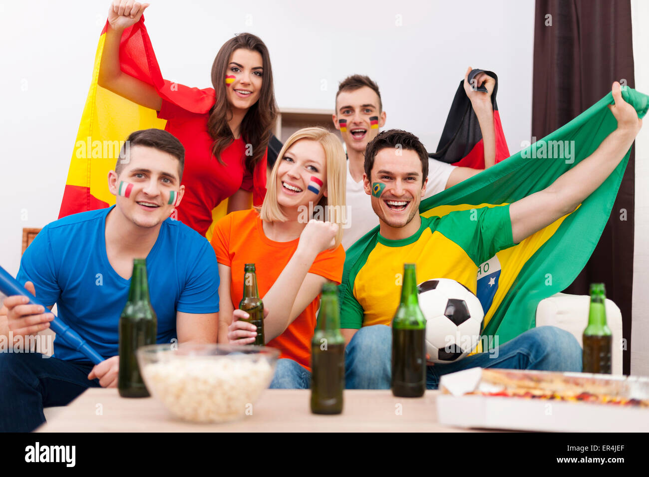 Friends watching football together Stock Photo - Alamy