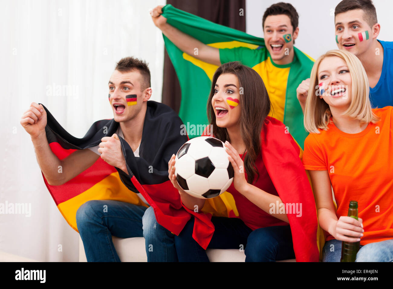 Friends watching football together Stock Photo - Alamy