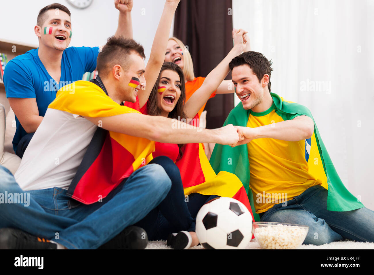 Friends watching football together Stock Photo - Alamy