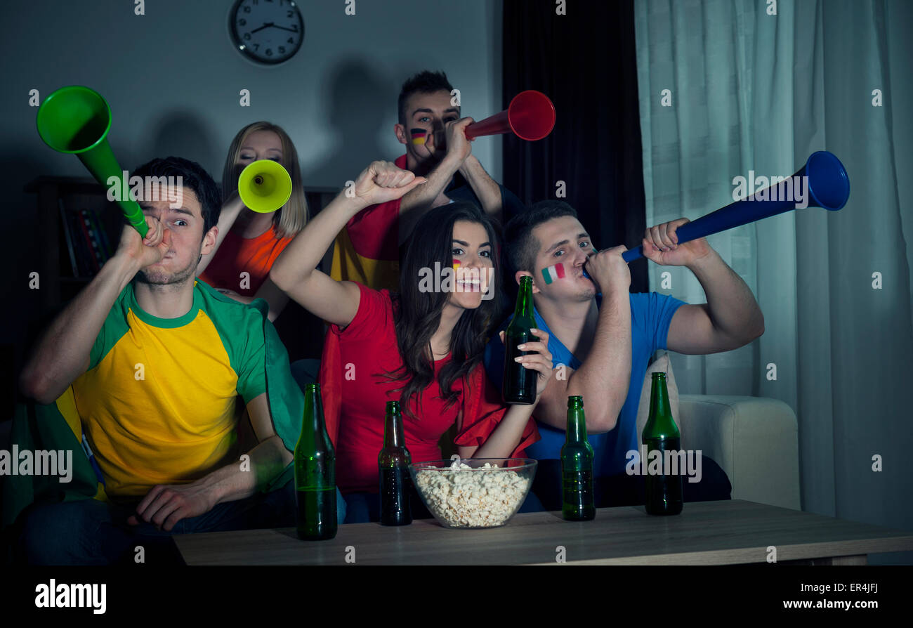Friends watching football together Stock Photo - Alamy