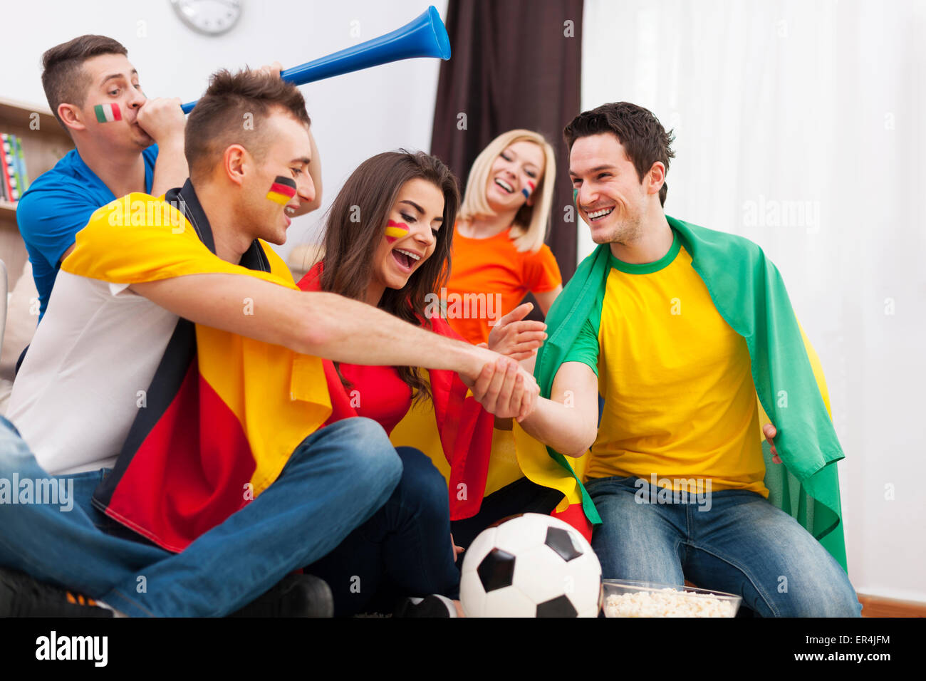 Friends watching football together Stock Photo - Alamy