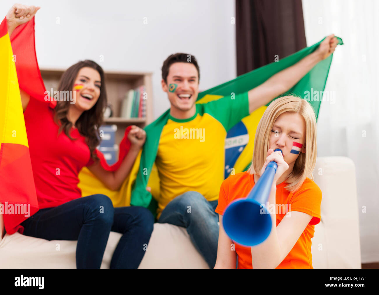 Friends watching football together Stock Photo - Alamy