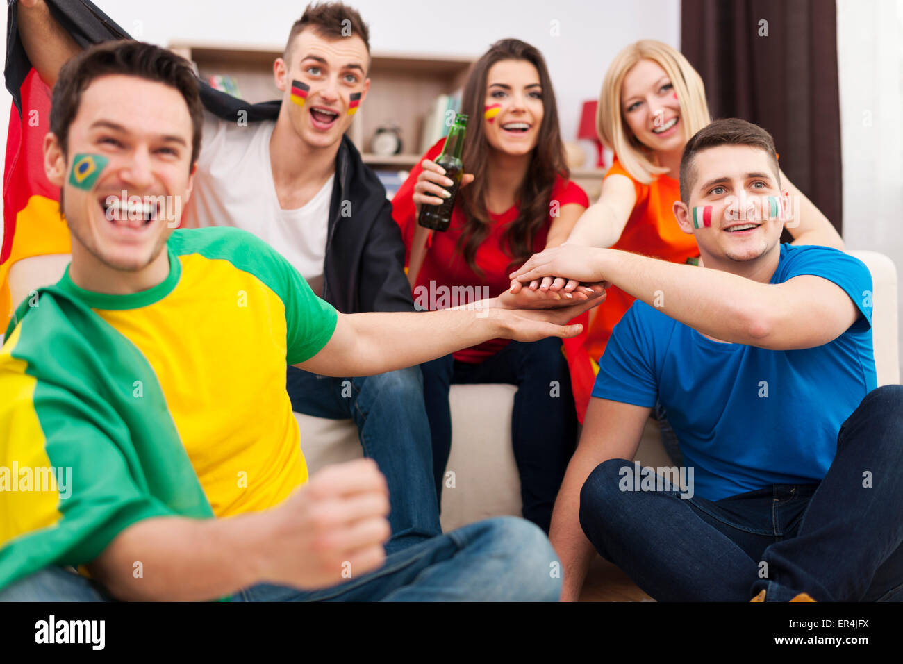 Friends watching football together Stock Photo - Alamy