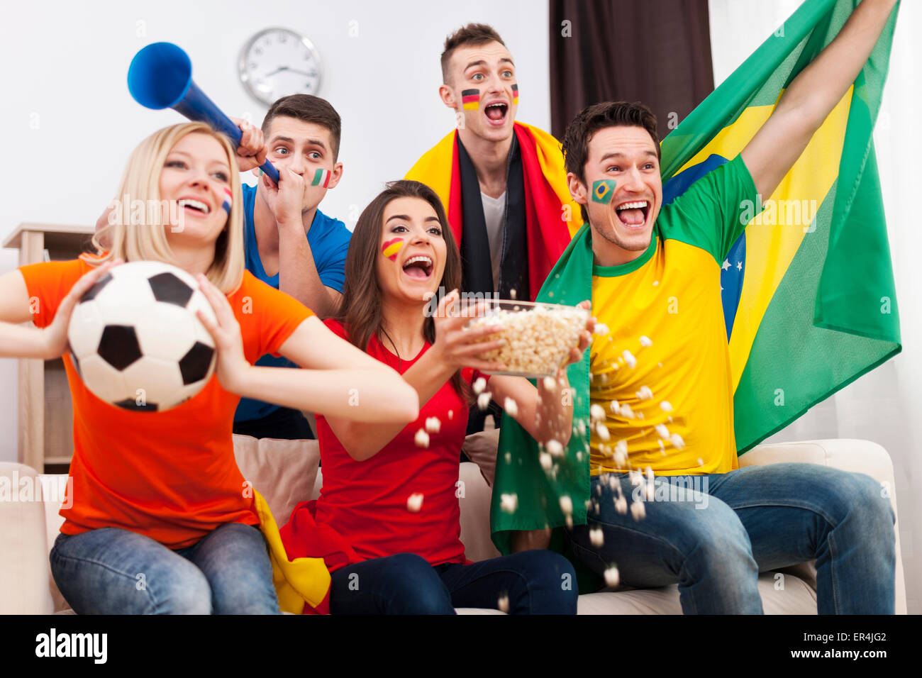 Friends watching football together Stock Photo - Alamy