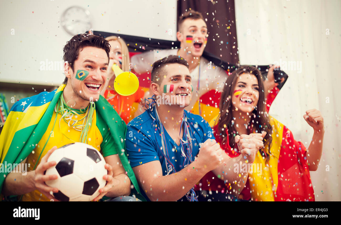 Friends watching football together Stock Photo - Alamy