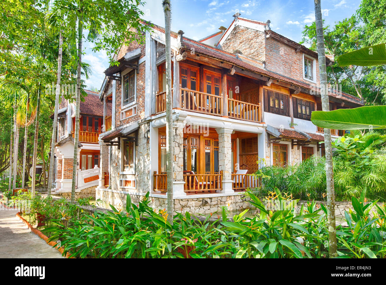 asian tropical garden with traditional bridge and buildings, Vietnam ...