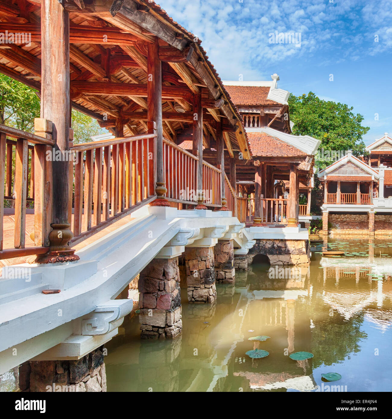 asian tropical garden with traditional bridge and buildings, Vietnam ...