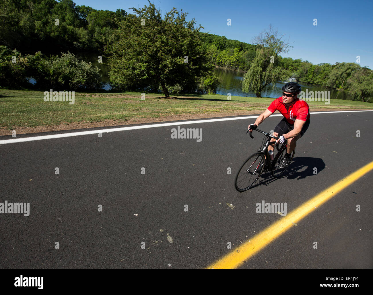 Man riding a road bike on a paved roadway Stock Photo - Alamy