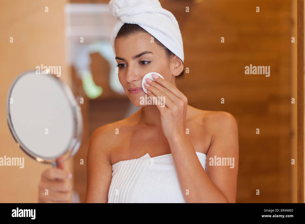 Beautiful woman washing her face in the bathroom hi-res stock ...