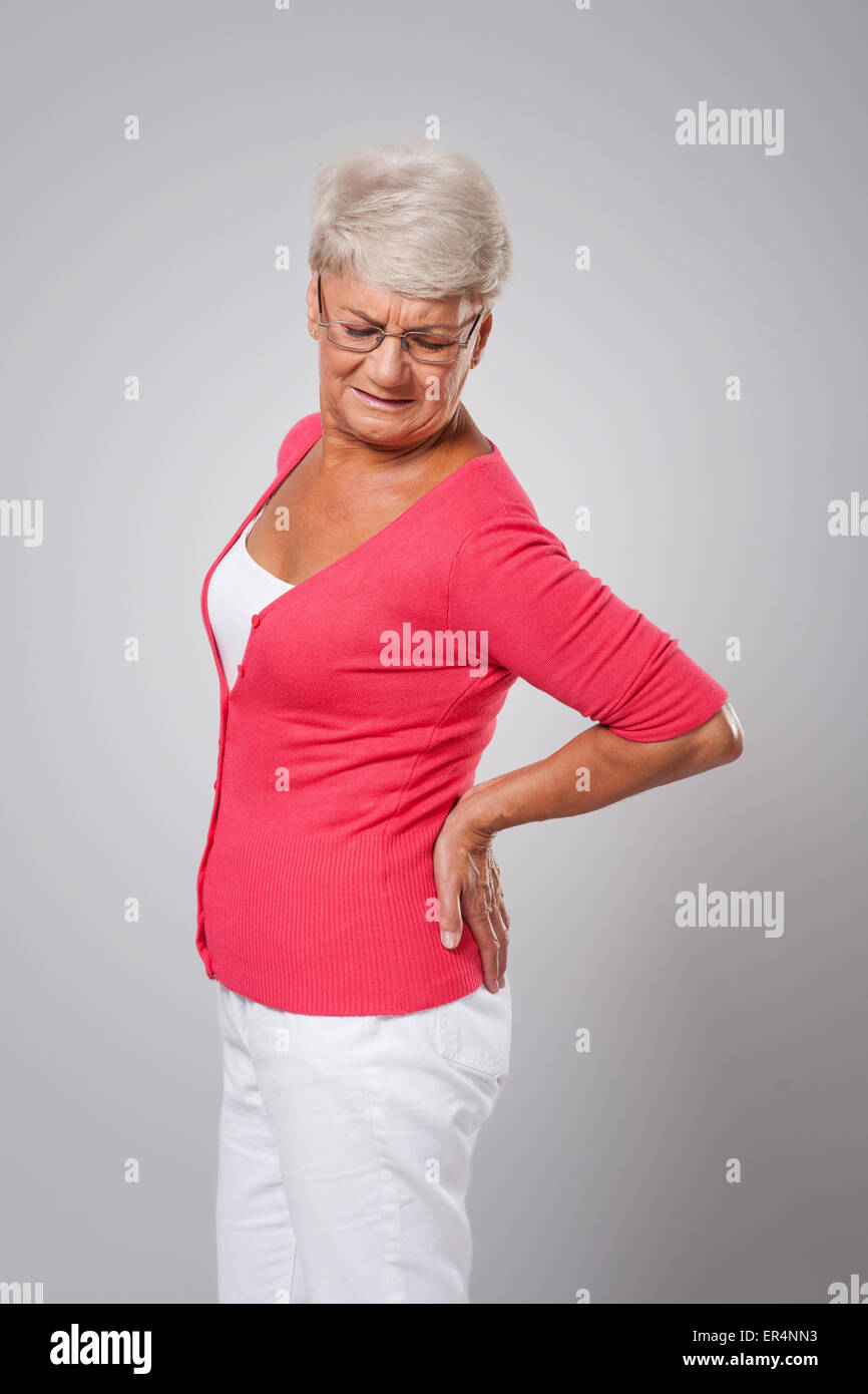 Lady with back pain Stock Photo - Alamy