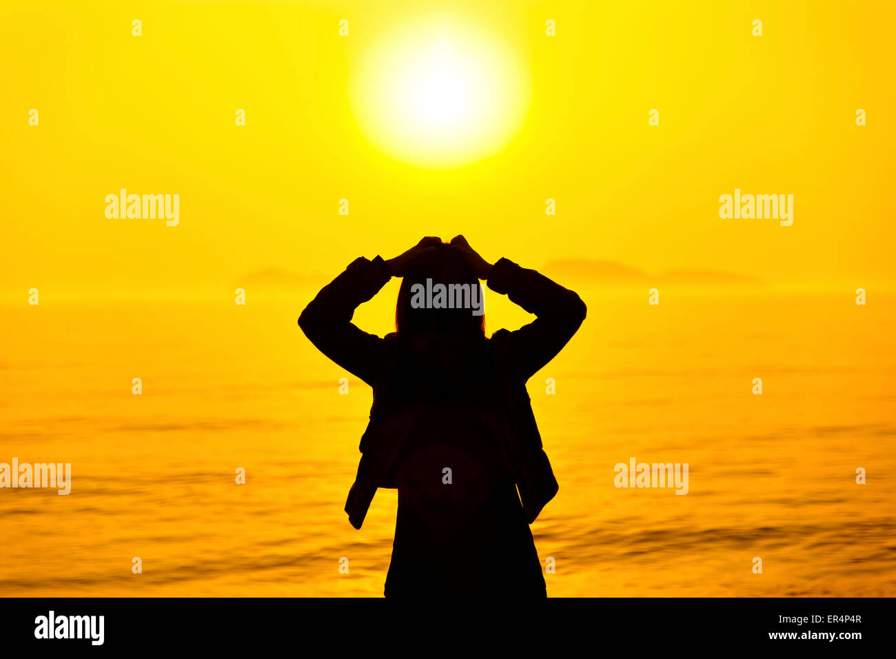 Silhouette of woman thinking on the beach at sunset Stock Photo - Alamy