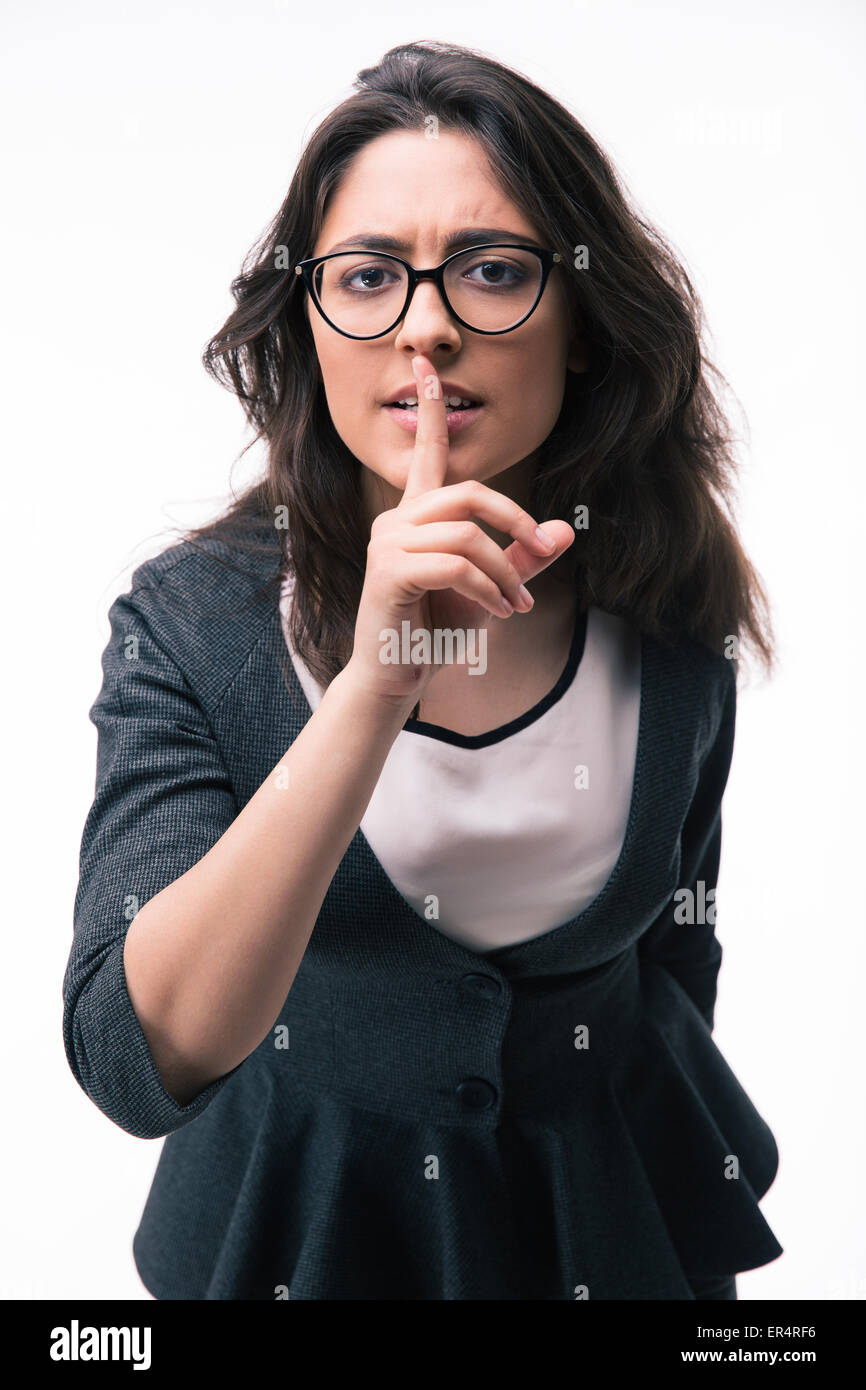 Businesswoman in glasses showing finger over lips isolated on a white ...