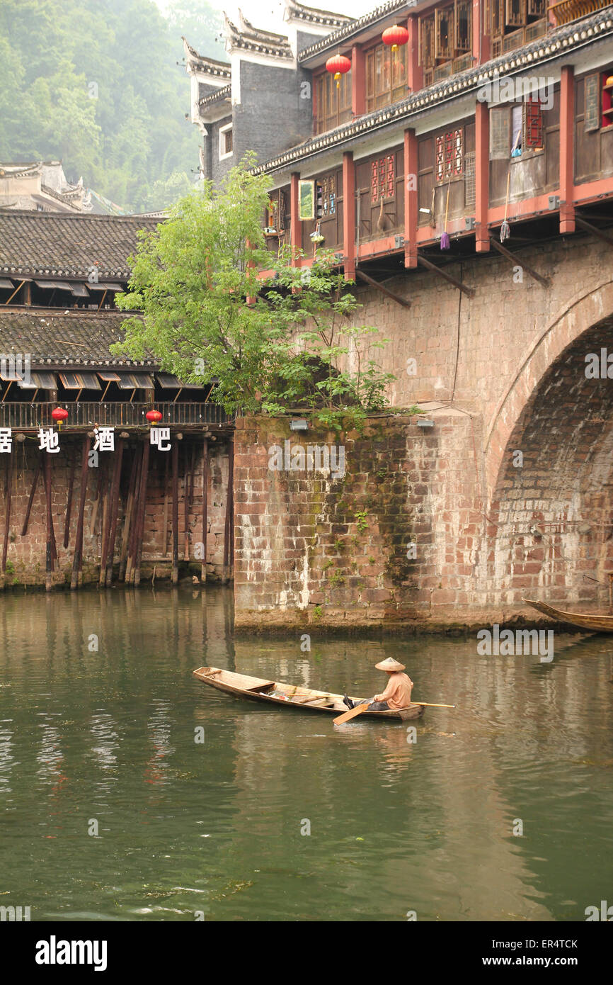 FENGHUANG - MAY 12: Wooden boat and wooden houses at tuojiang river in ...