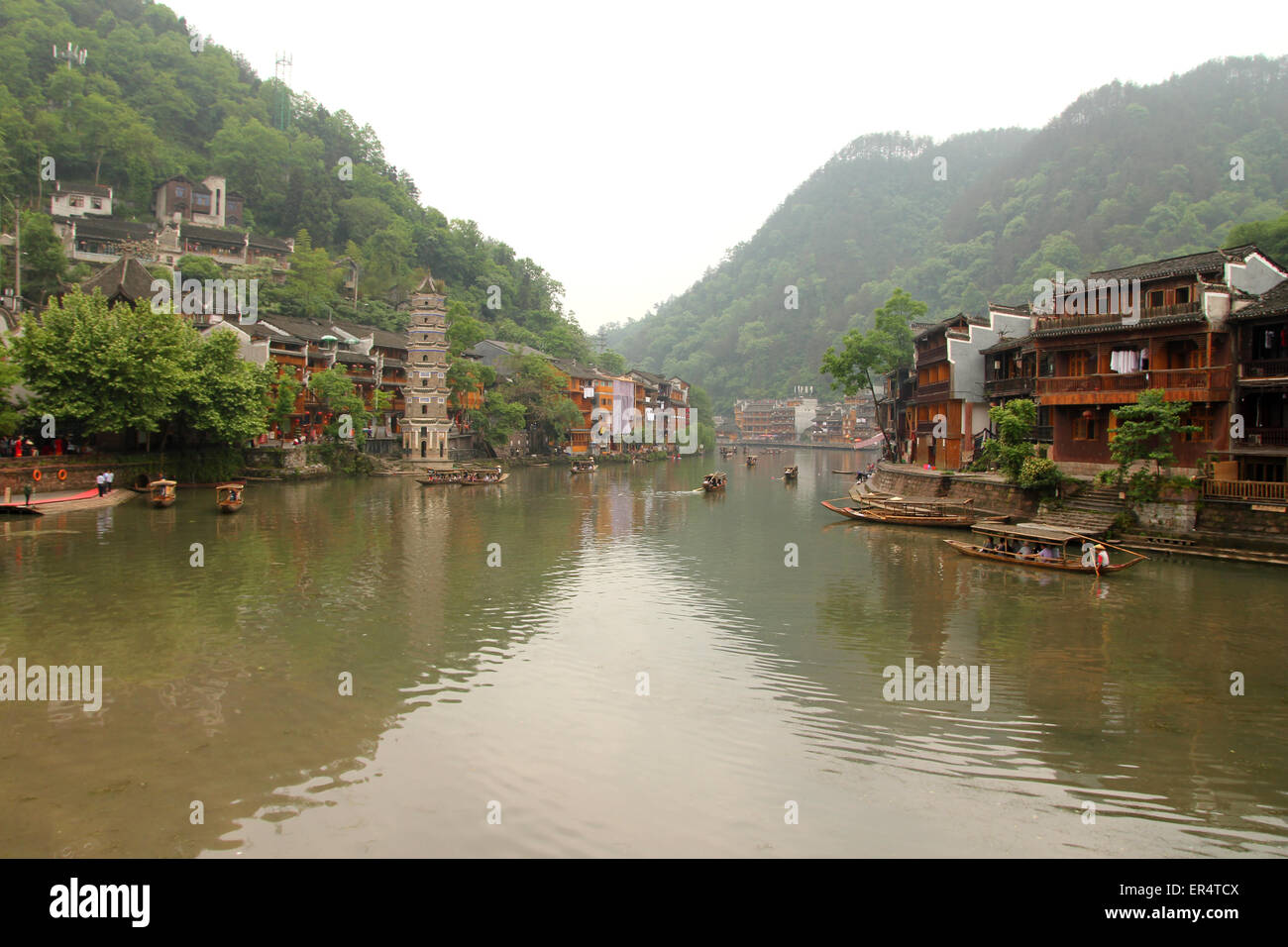 FENGHUANG - MAY 12: Wooden boat and wooden houses at tuojiang river in ...