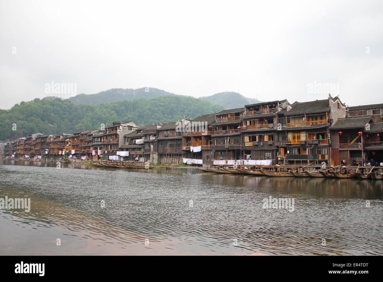 FENGHUANG - MAY 12: Wooden boat and wooden houses at tuojiang river in ...