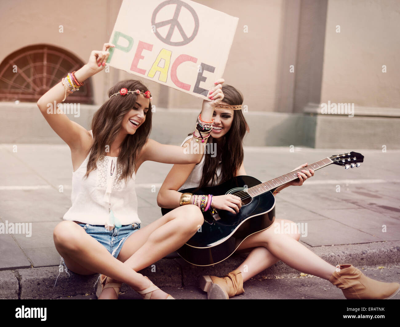 Beautiful hippie friends playing guitar in the city. Krakow, Poland ...