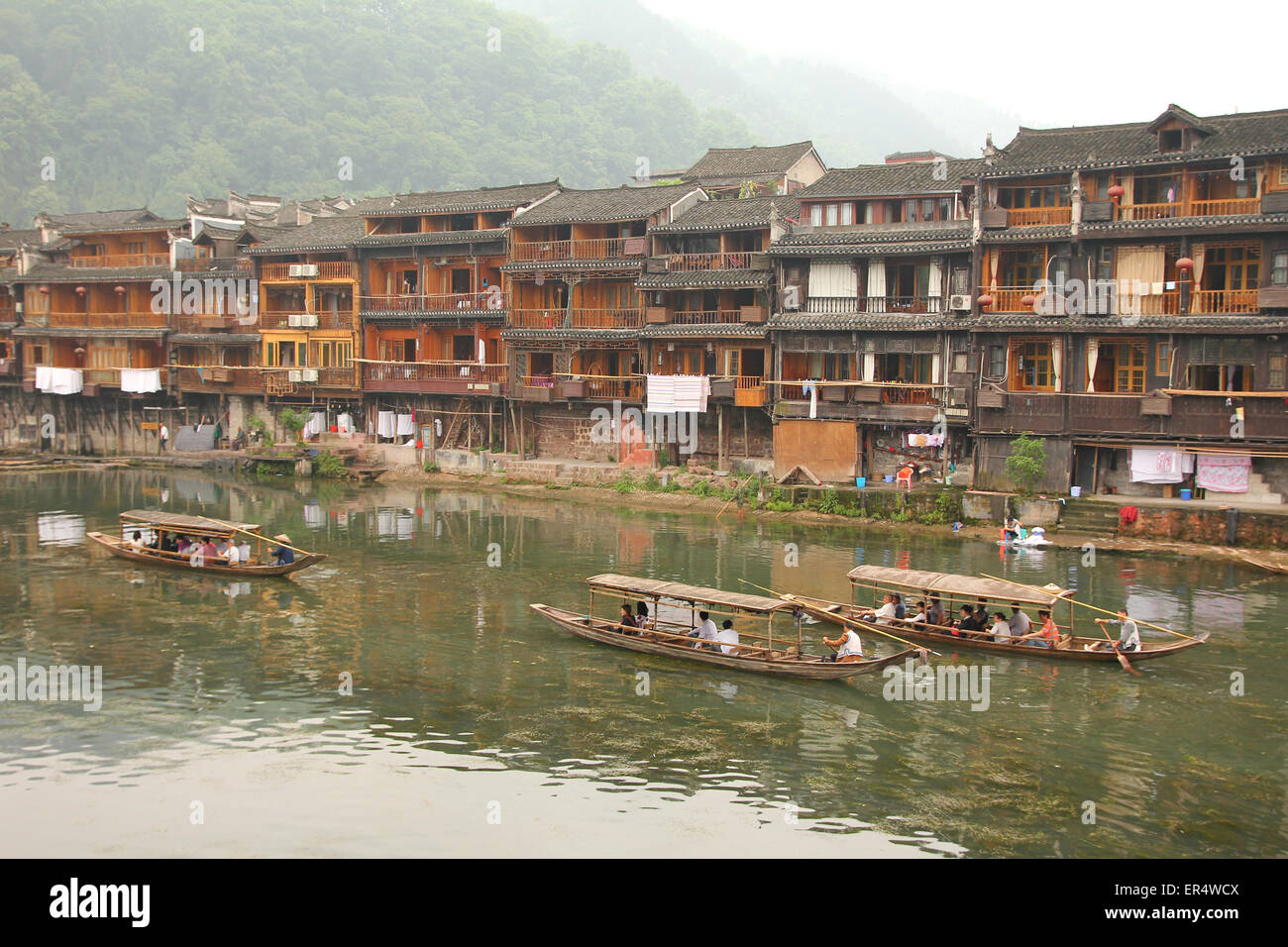 FENGHUANG - MAY 12: Wooden boat and wooden houses at tuojiang river in ...