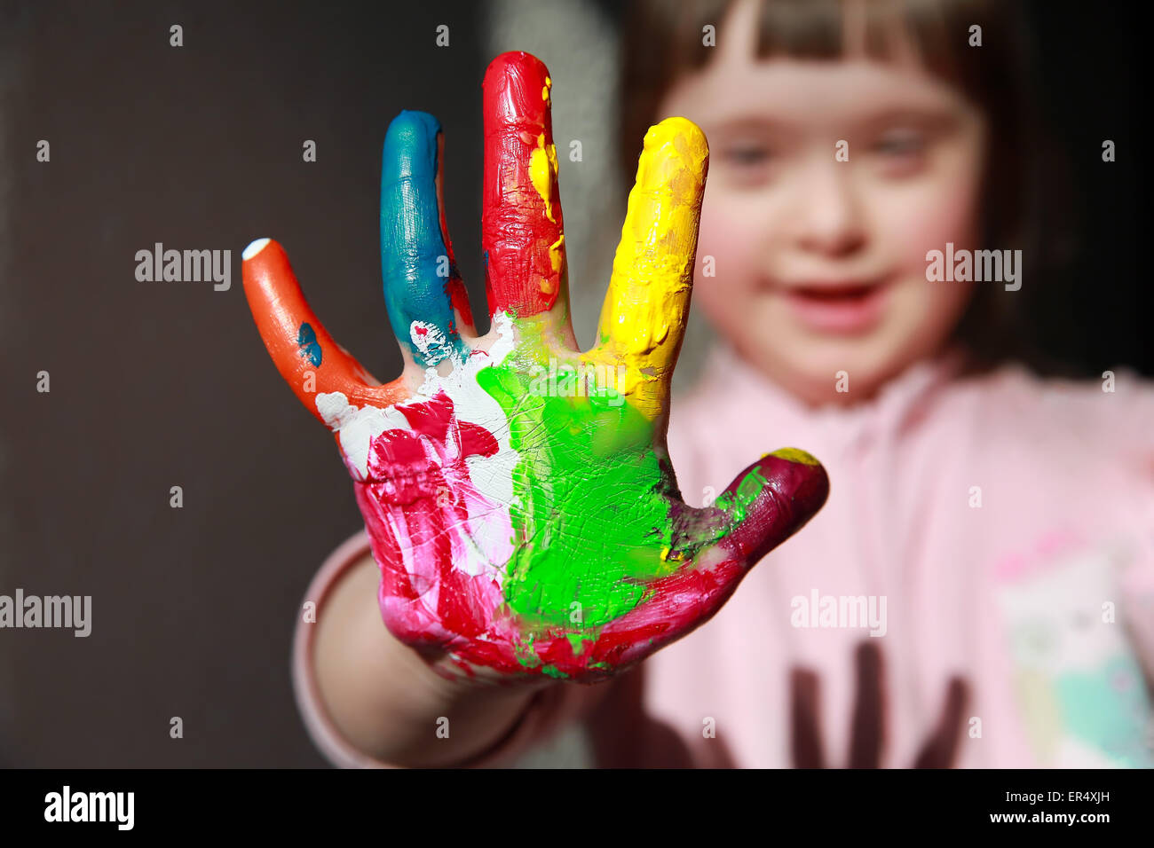 Cute little girl with painted hands Stock Photo - Alamy