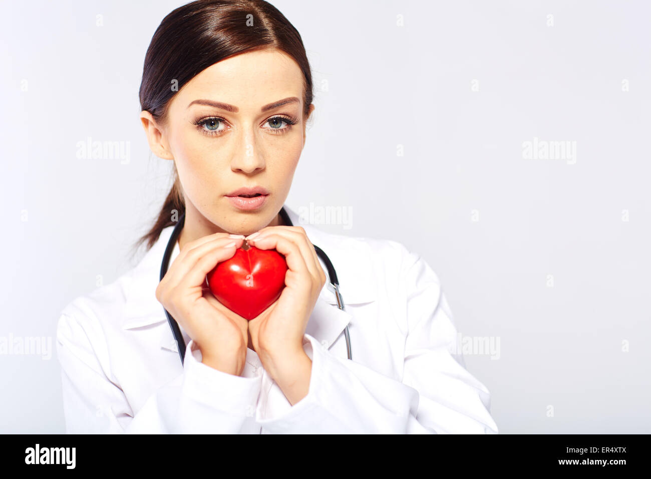 female doctor holding a heart Stock Photo - Alamy