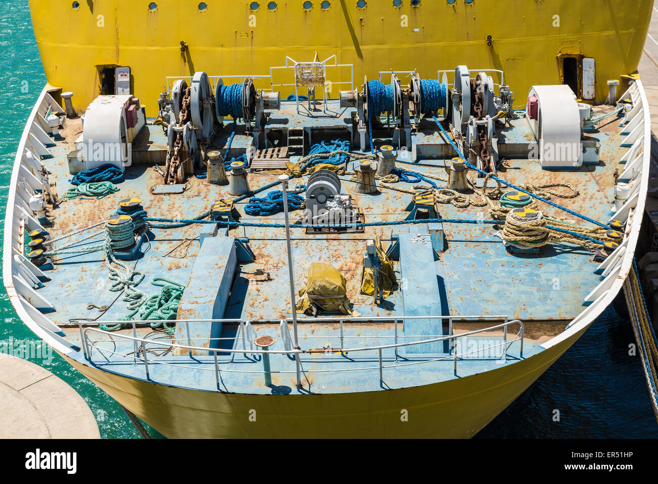 Deck of a ship with coils of chains and ropes tied in a harbor Stock ...