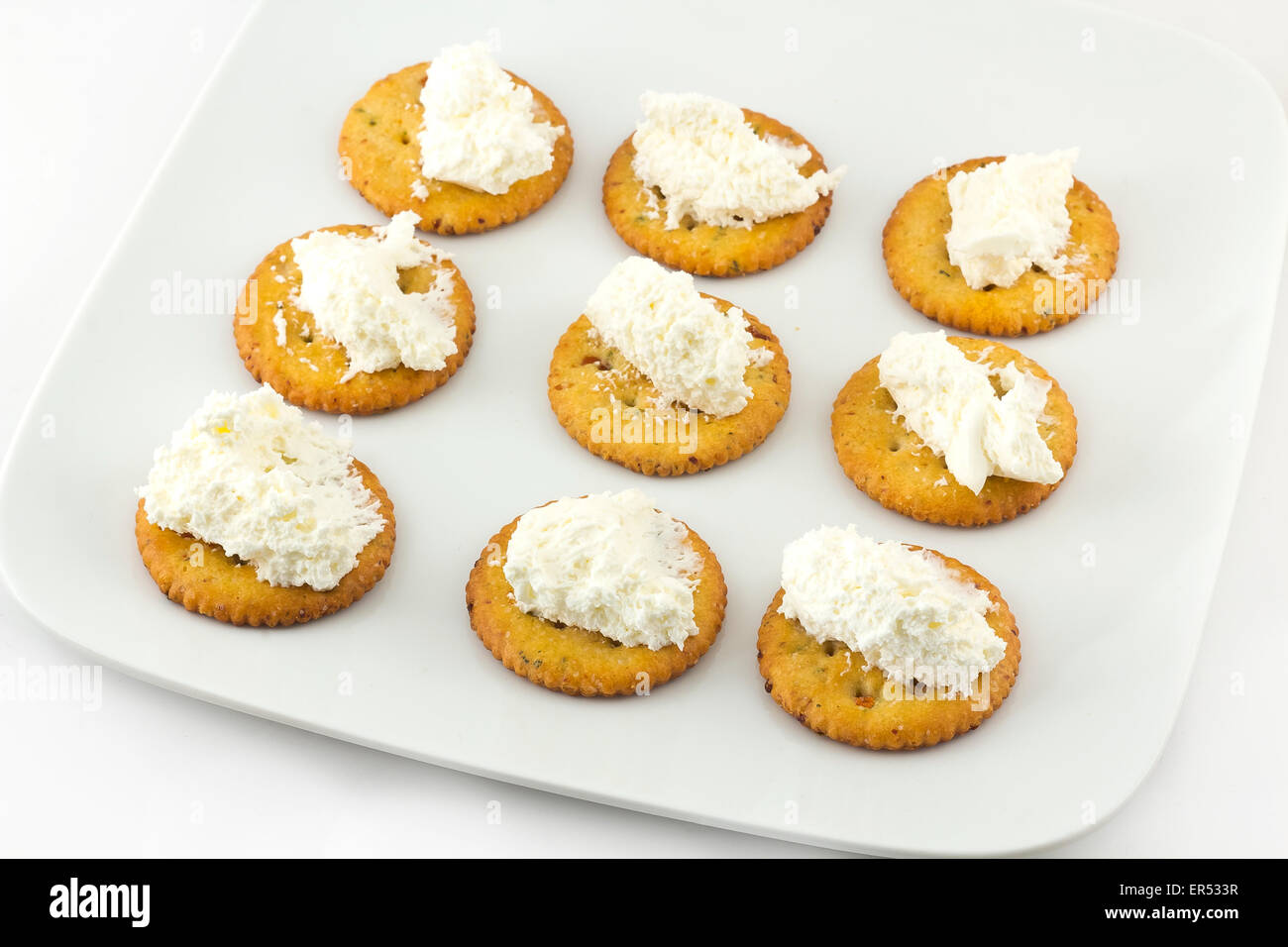 Snack plate of crackers topped with whipped cream cheese Stock Photo ...