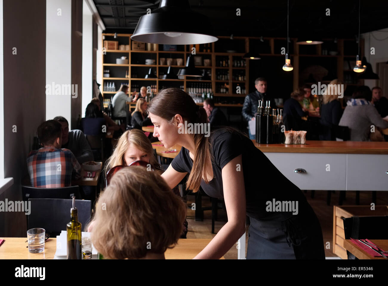 People eating in the Kitchen Restaurant in the old town of Vilnius a ...