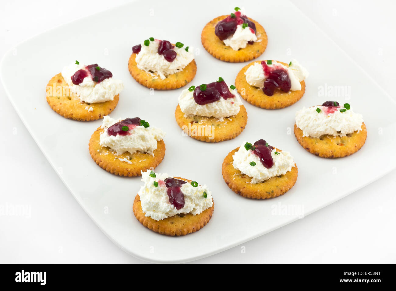 Snack plate of crackers topped with whipped cream cheese and grape ...