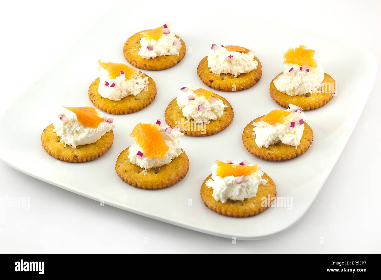 Snack plate of crackers topped with whipped cream cheese and smoked ...