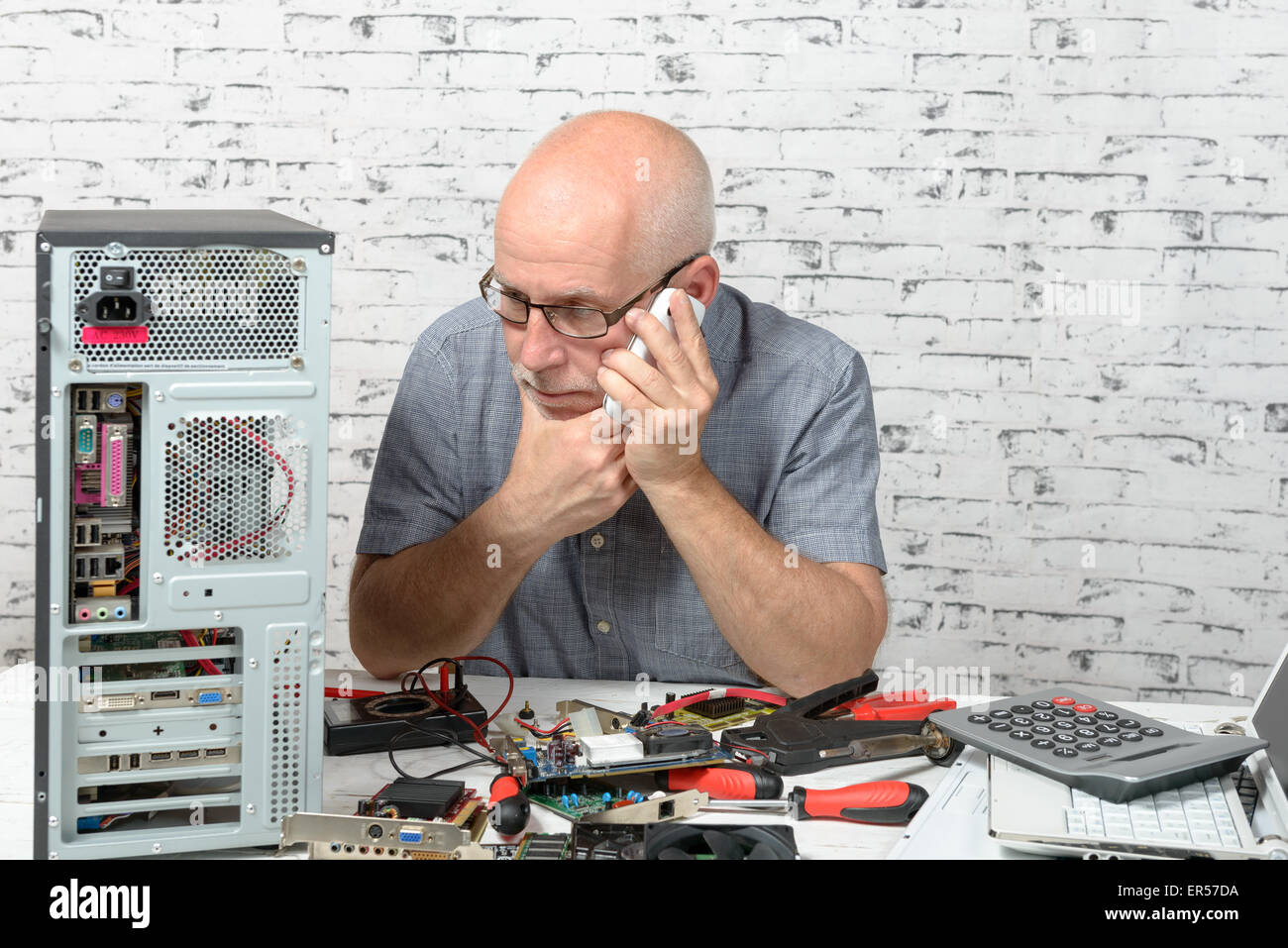 a technician repairing a computer with different tools Stock Photo - Alamy