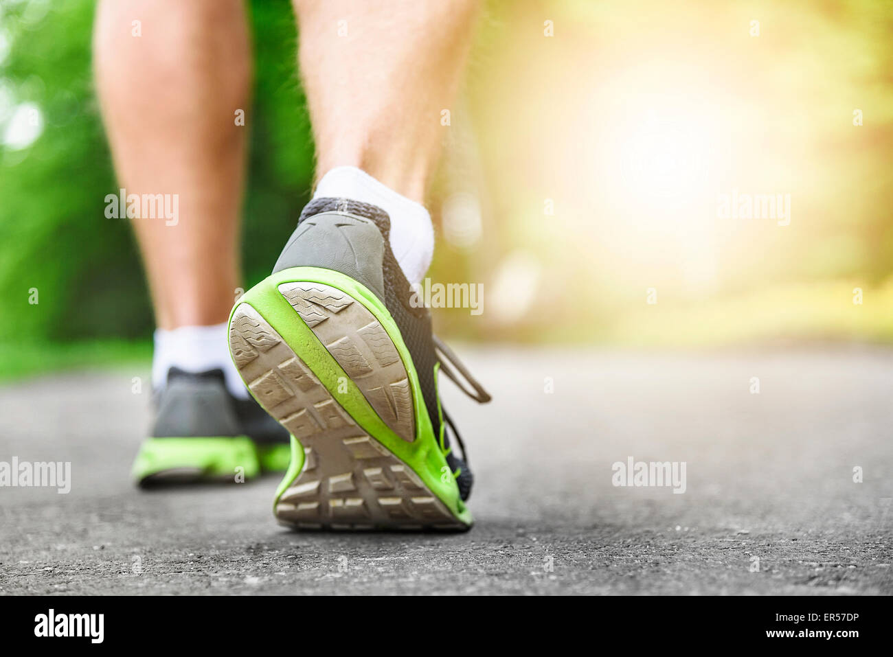 Athlete runner feet running on road Stock Photo - Alamy