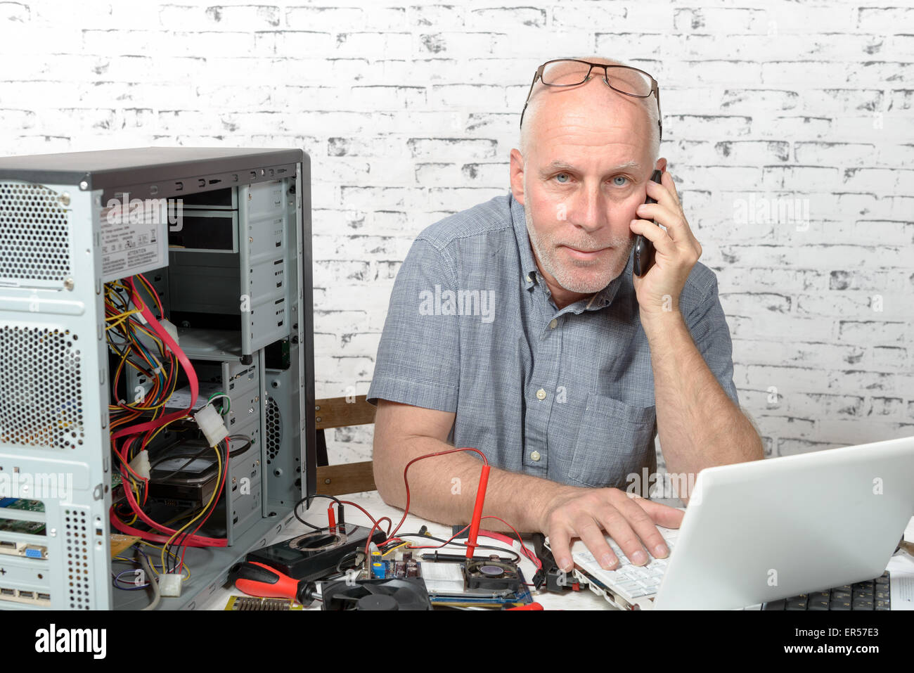 a technician repairing a computer with different tools Stock Photo - Alamy
