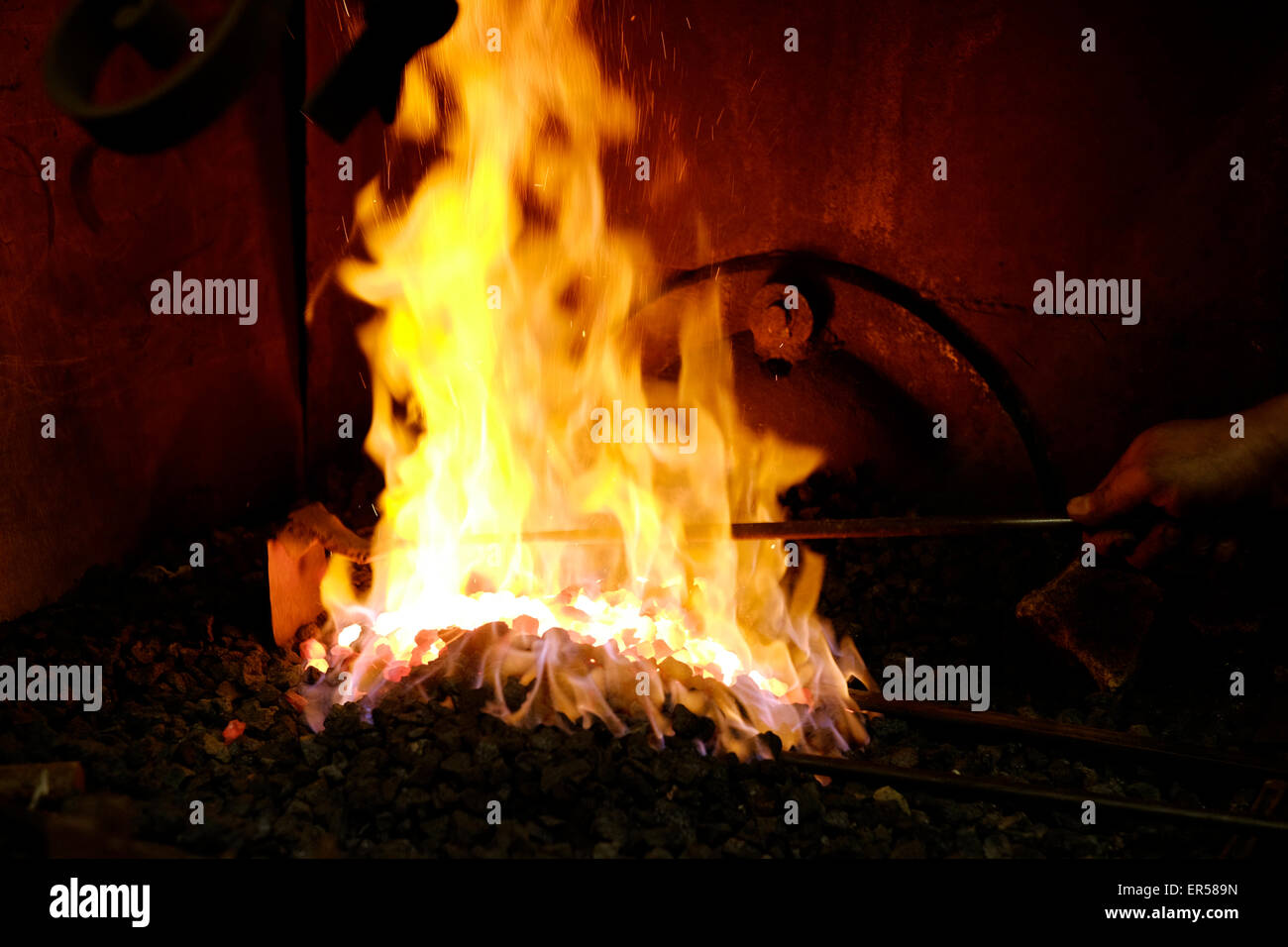 roaring flames as a blacksmith is at work in his forge in southsea ...