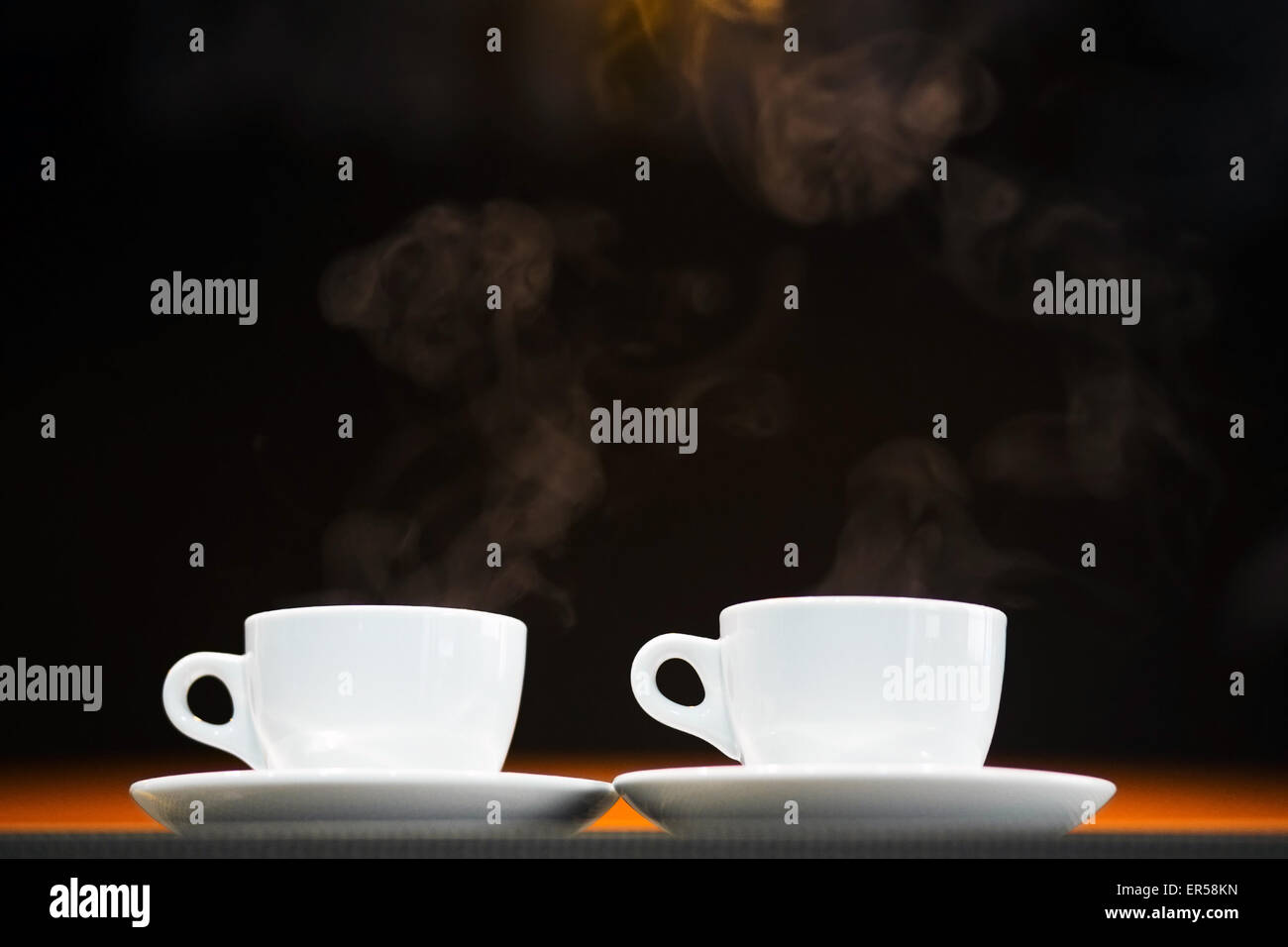 Two white cups with hot drinks Stock Photo - Alamy